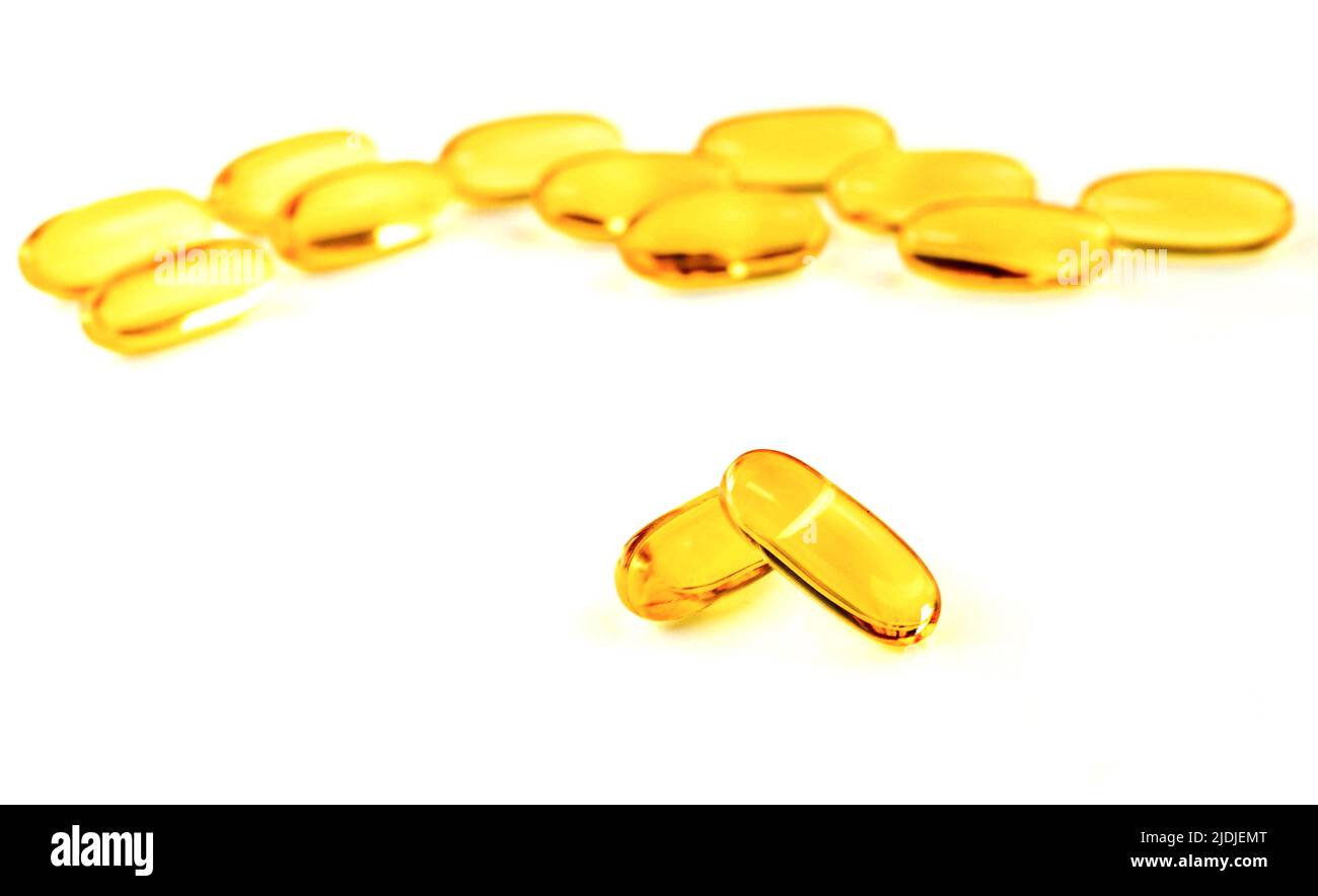 Oily fish, in capsules, on a white background Stock Photo - Alamy