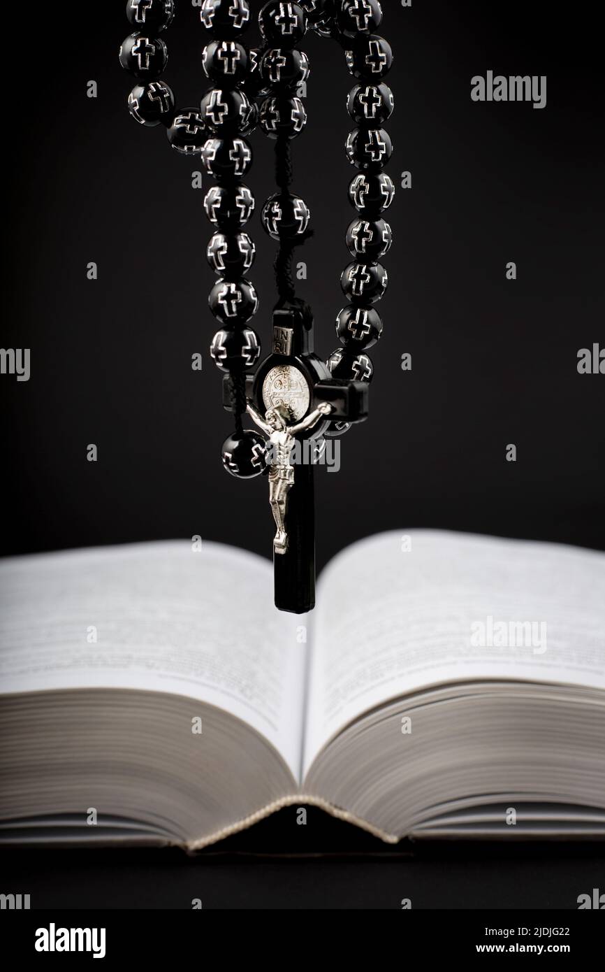 Traditional christian holy religious wooden rosary with bible on black ...