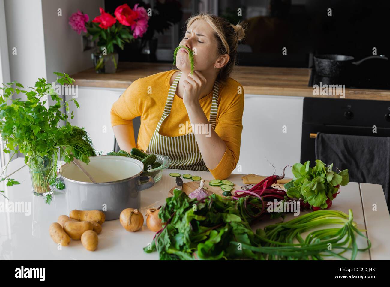 Humor healthy food concept, Funny young cute woman is cooking in ...