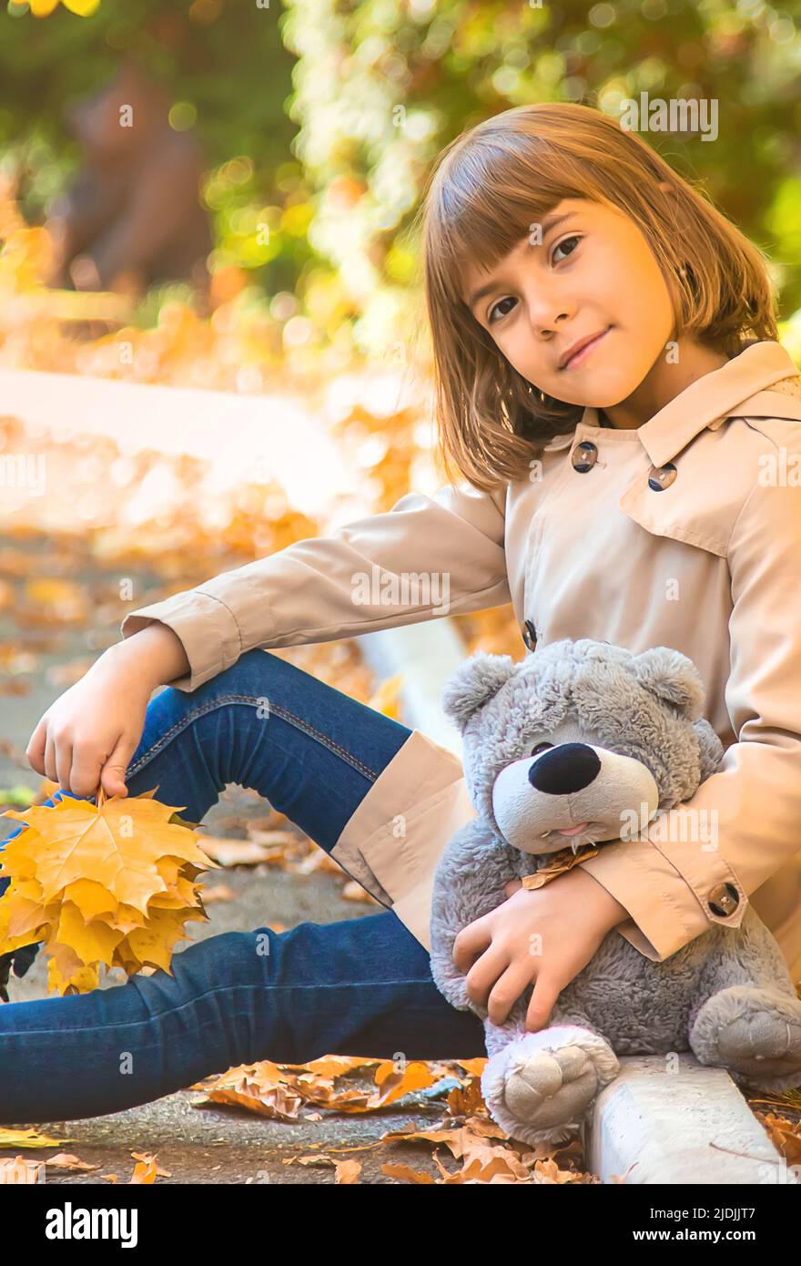 Children in the park with autumn leaves. Selective focus Stock Photo ...