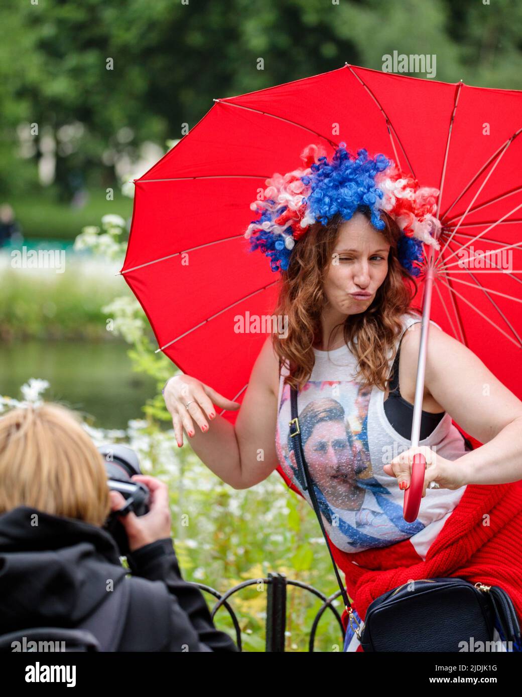Spectator dressed in red, white and blue poses for a photo on the ...