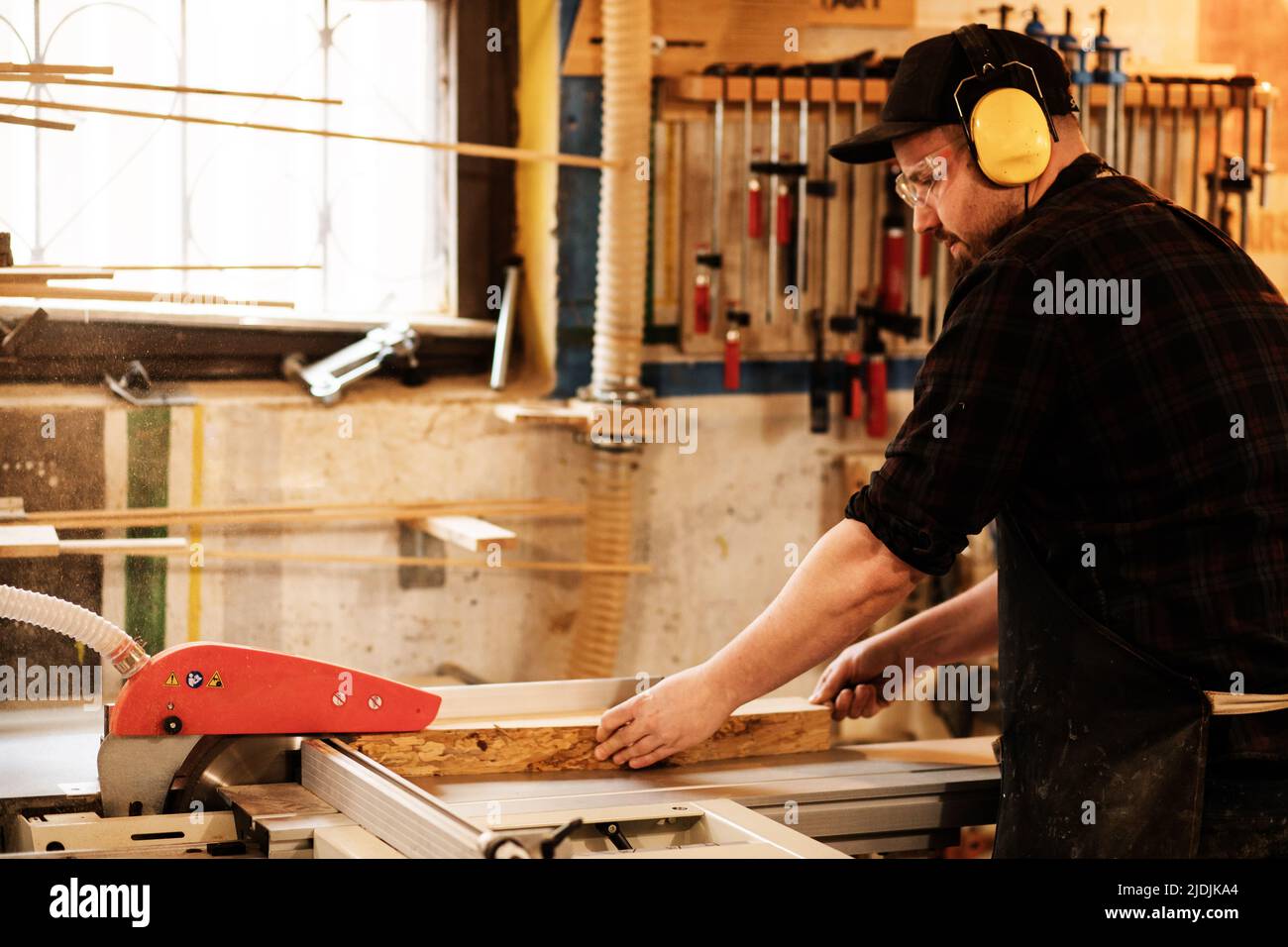 Woodworker, carpenter, joiner in protective uniform, eyewear ...
