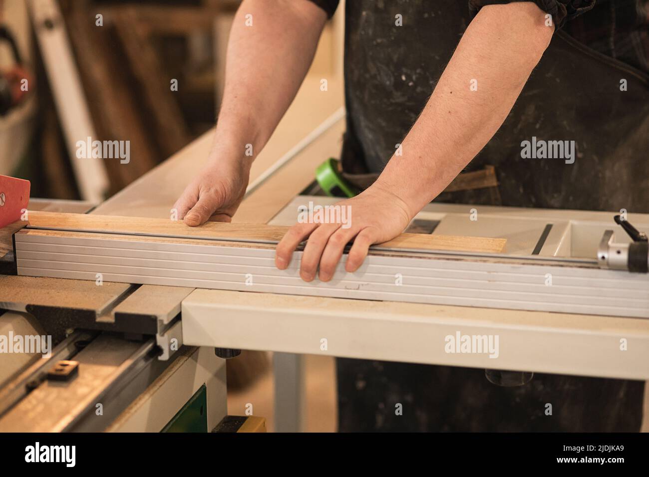 Close-up cropped male carpenter hands working with wood timber ...