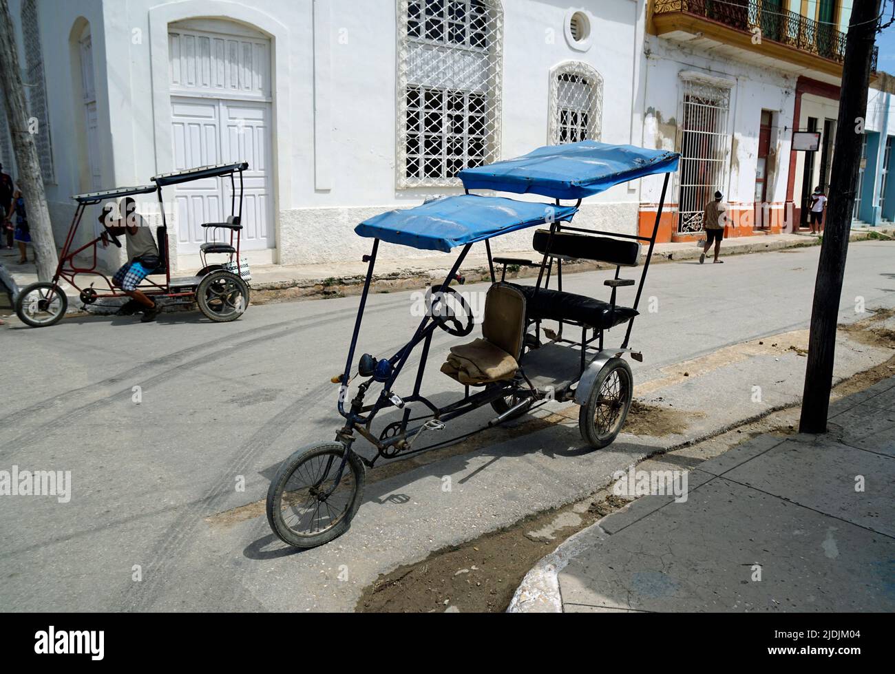 run down bike taxi in the streets of trinidad Stock Photo - Alamy