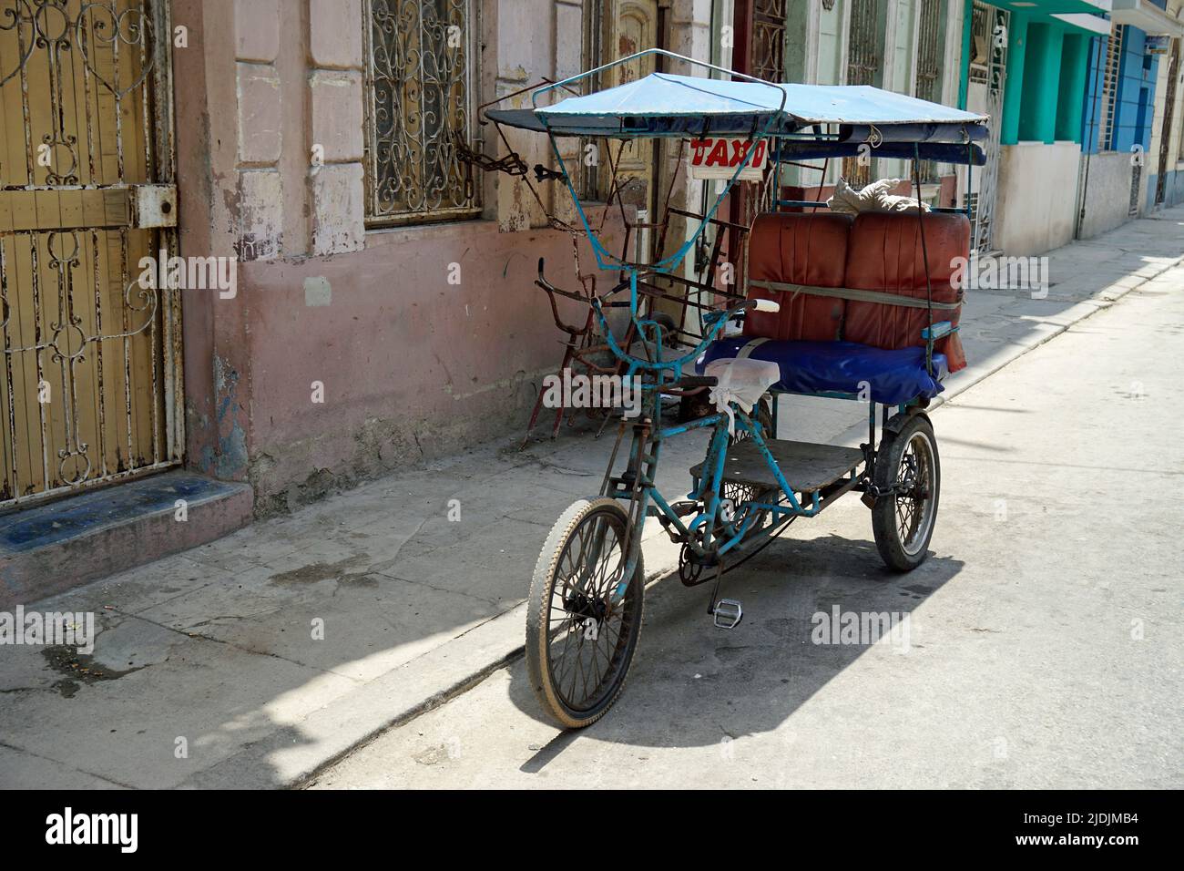 run down bike taxi in the streets of trinidad Stock Photo - Alamy
