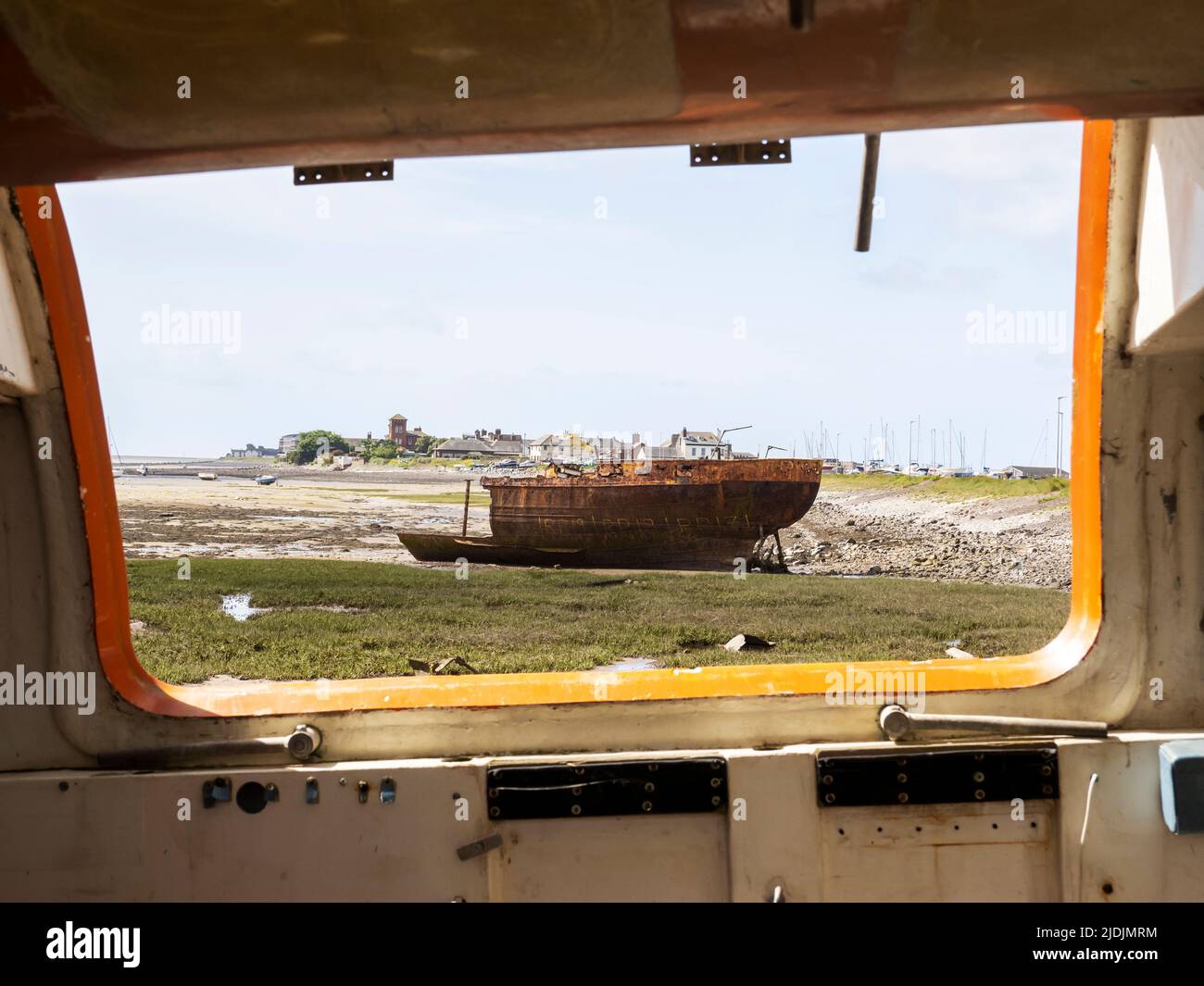 A shipwrecked boat seen through the window of a shipwrecked lifeboat on ...