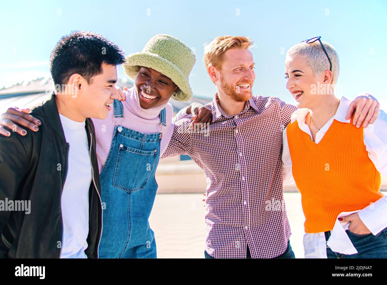 Group of four friends laughing out loud outdoor. Two couples talking ...