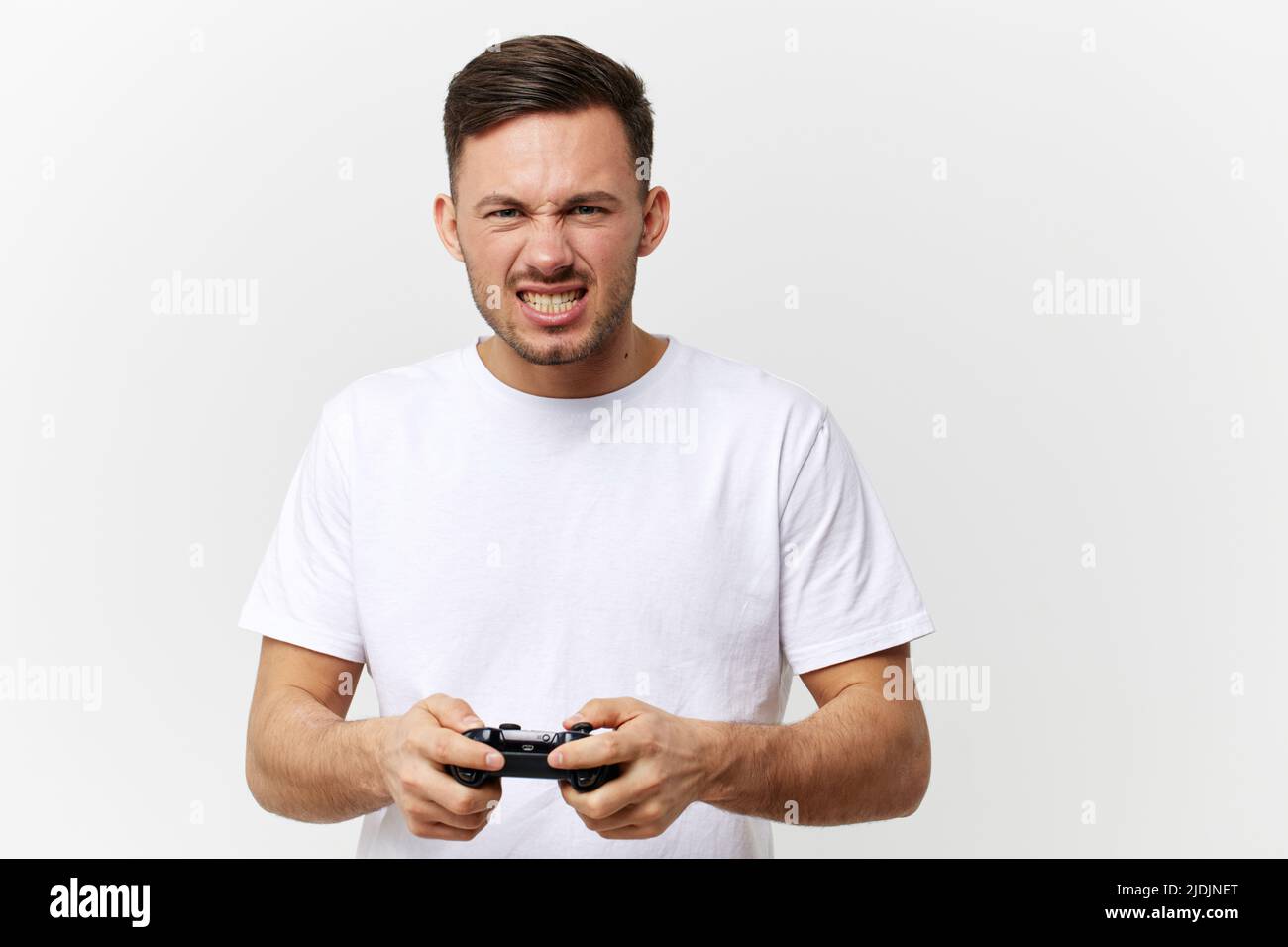 Aggressive angry tanned handsome man in basic t-shirt play difficult ...