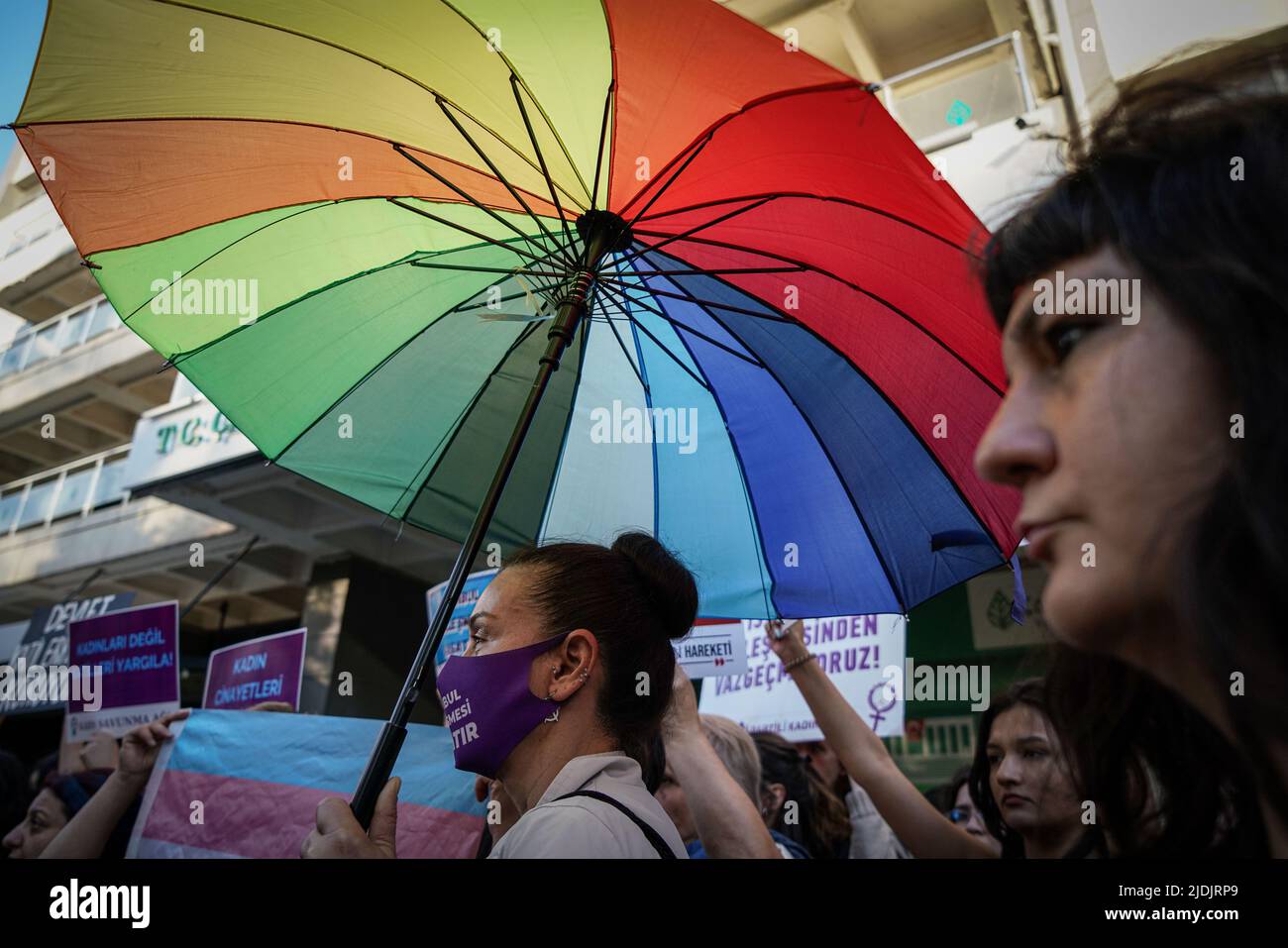 A protester holds a rainbow umbrella during the demonstration. Women's ...
