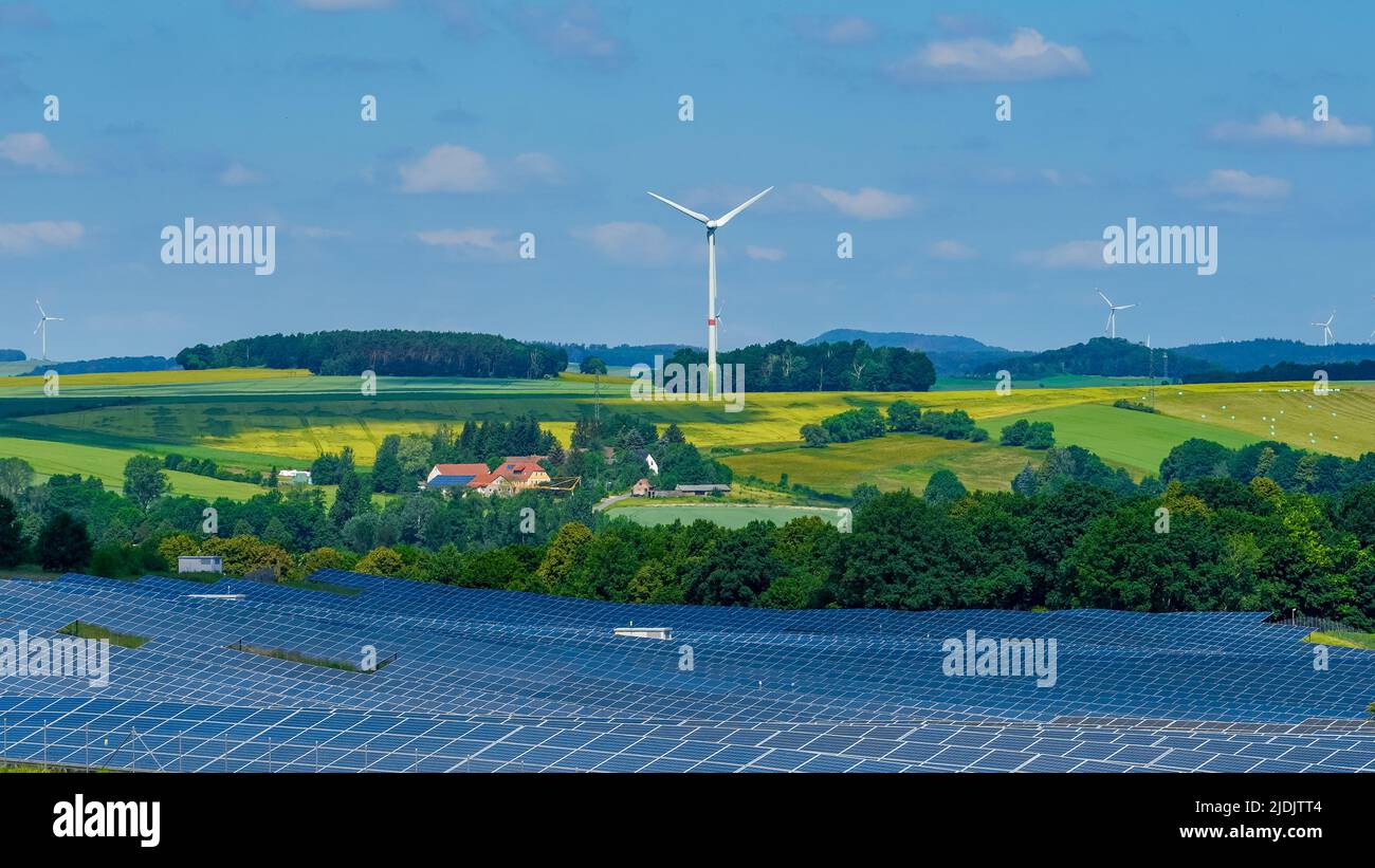 Sustainable energy - wind turbine behind photovoltaic energy plant ...