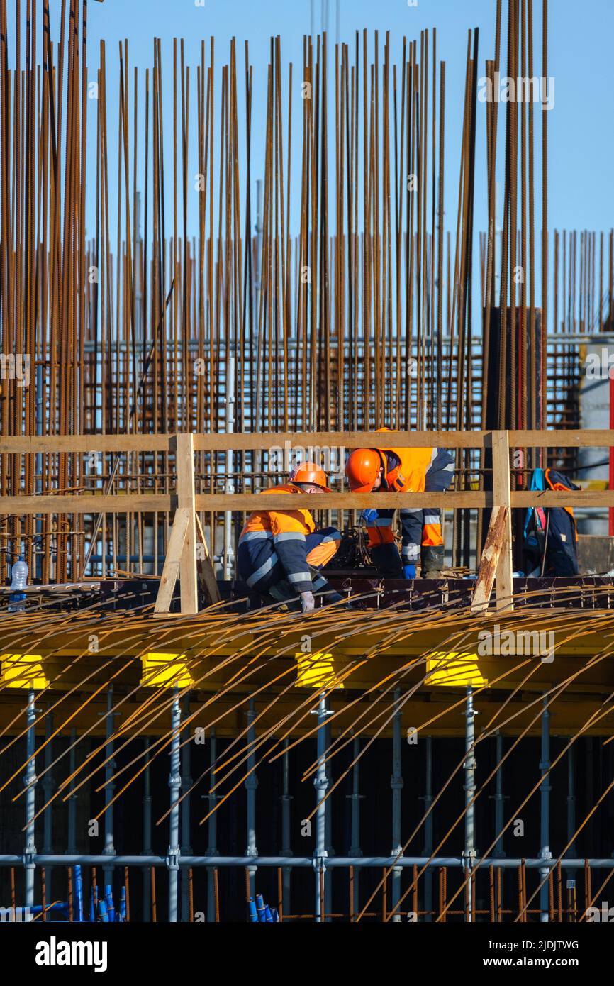 Unrecognizable male workers in protective uniforms and helmets sitting ...
