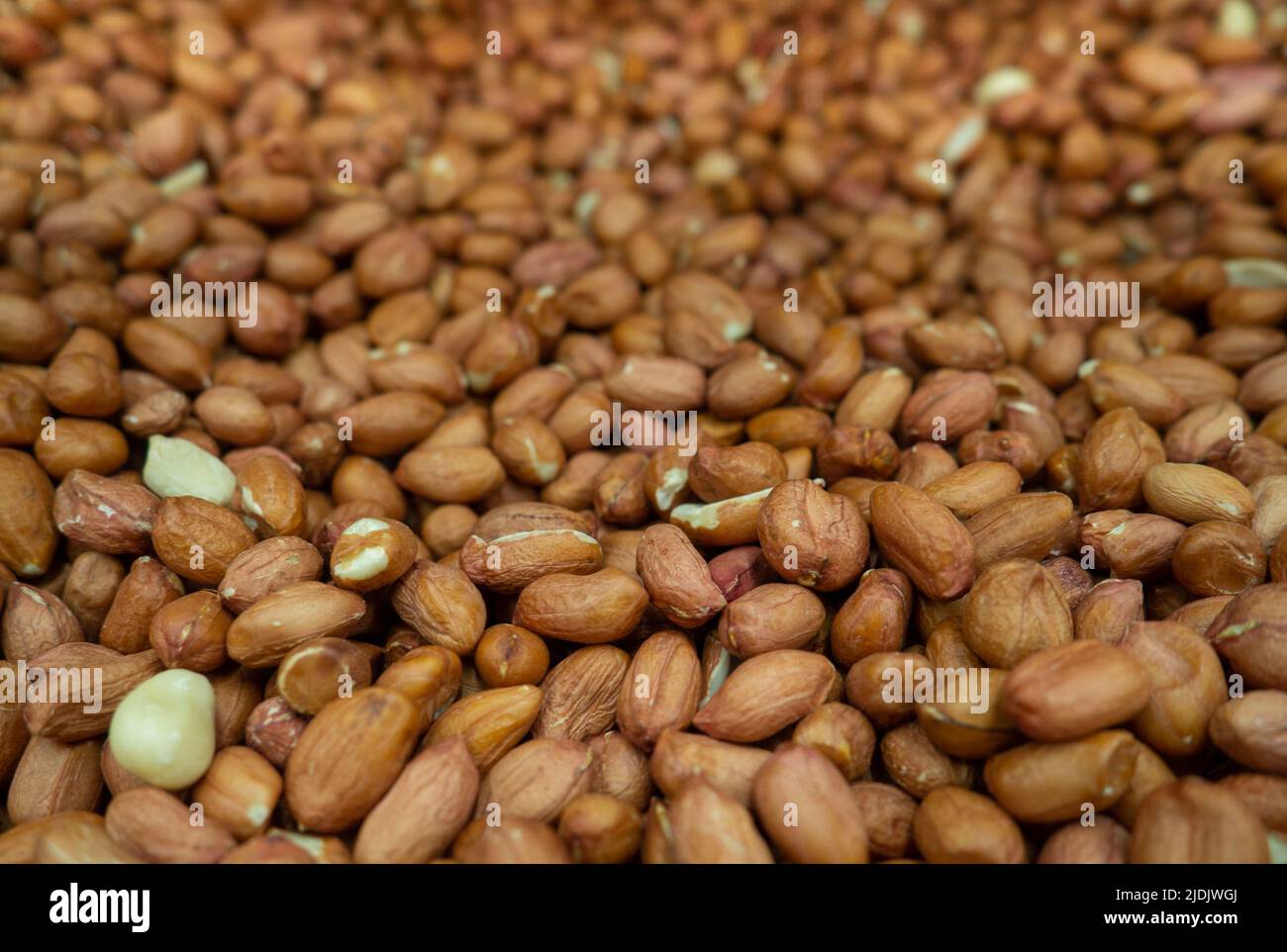 Peanut background. Healthy diet. Lots of nuts in the box. Peeled ...