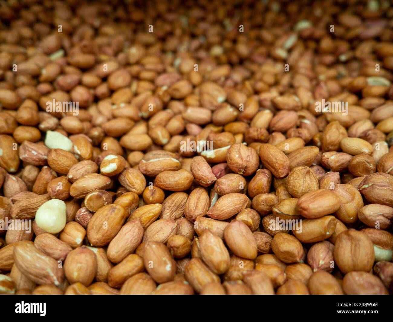 Peanut background. Healthy diet. Lots of nuts in the box. Peeled ...