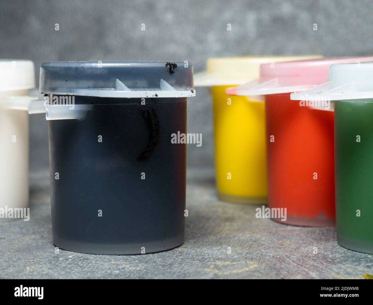 Jars of gouache on the table. Drawing set. Paints in cans Stock Photo ...