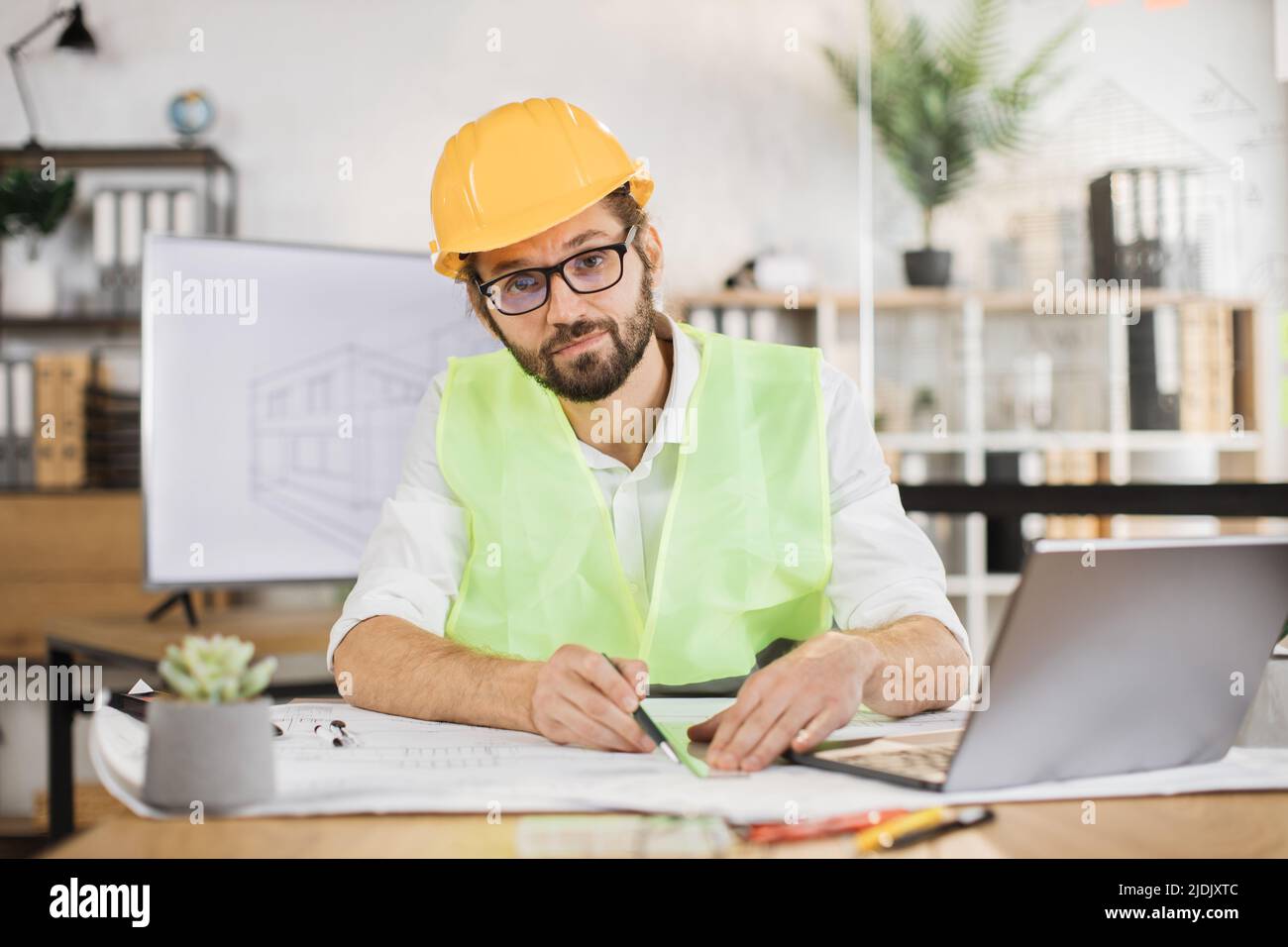 Architect man or male builder hold pen and ruler, writing and drawing ...