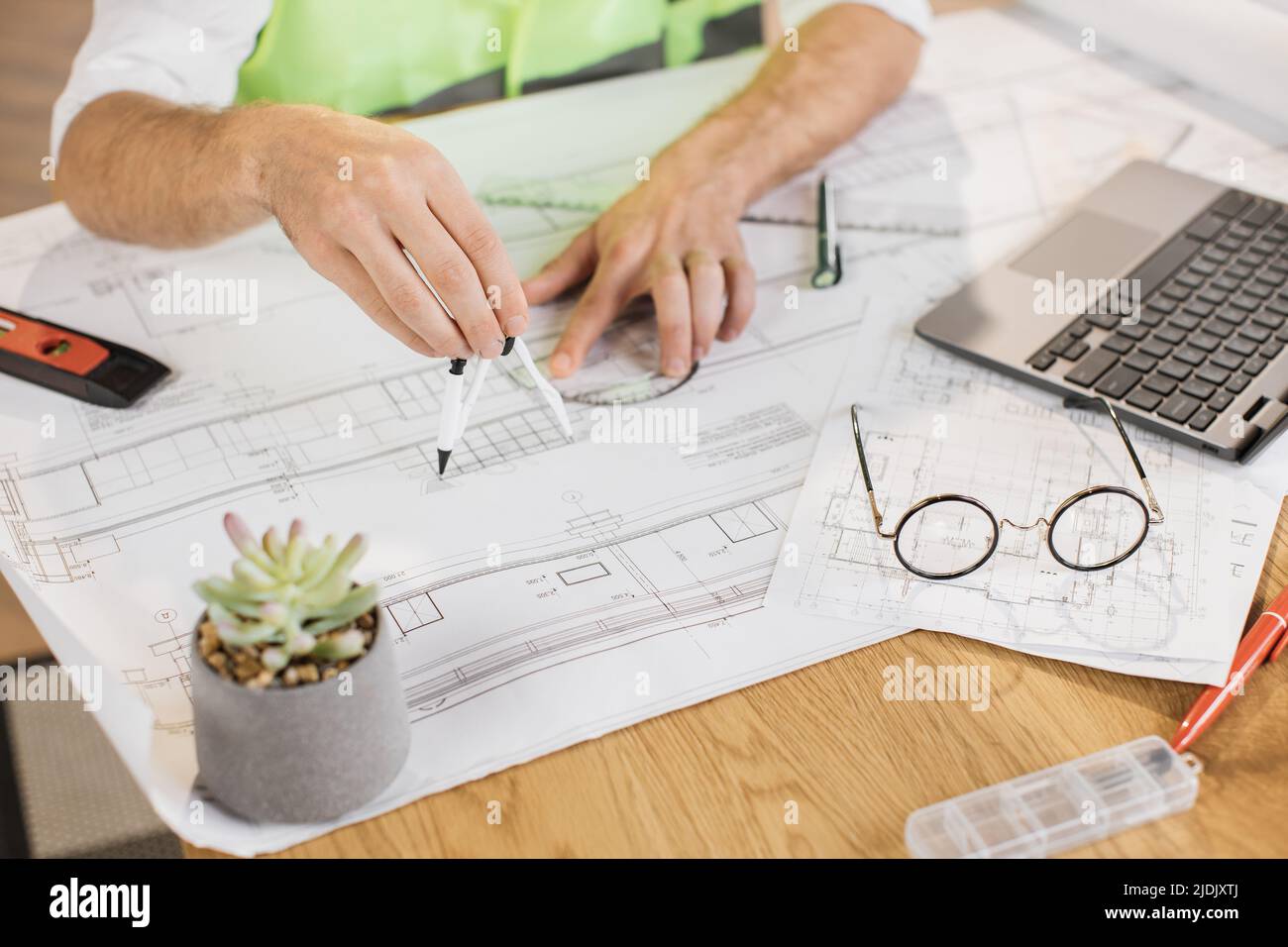 Closeup of hands of builder drawing renovation house equipment ...