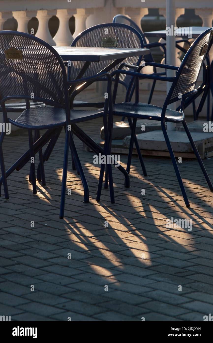 Empty terrace at sunset. Beautiful light and shadows on the pavement ...