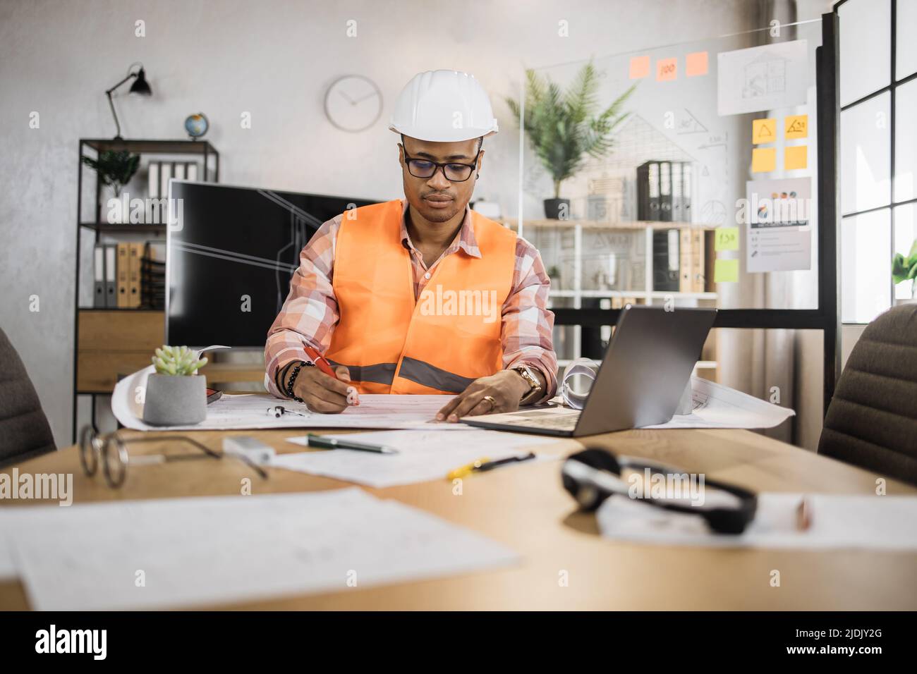 African American architect man or male builder hold pen and ruler ...