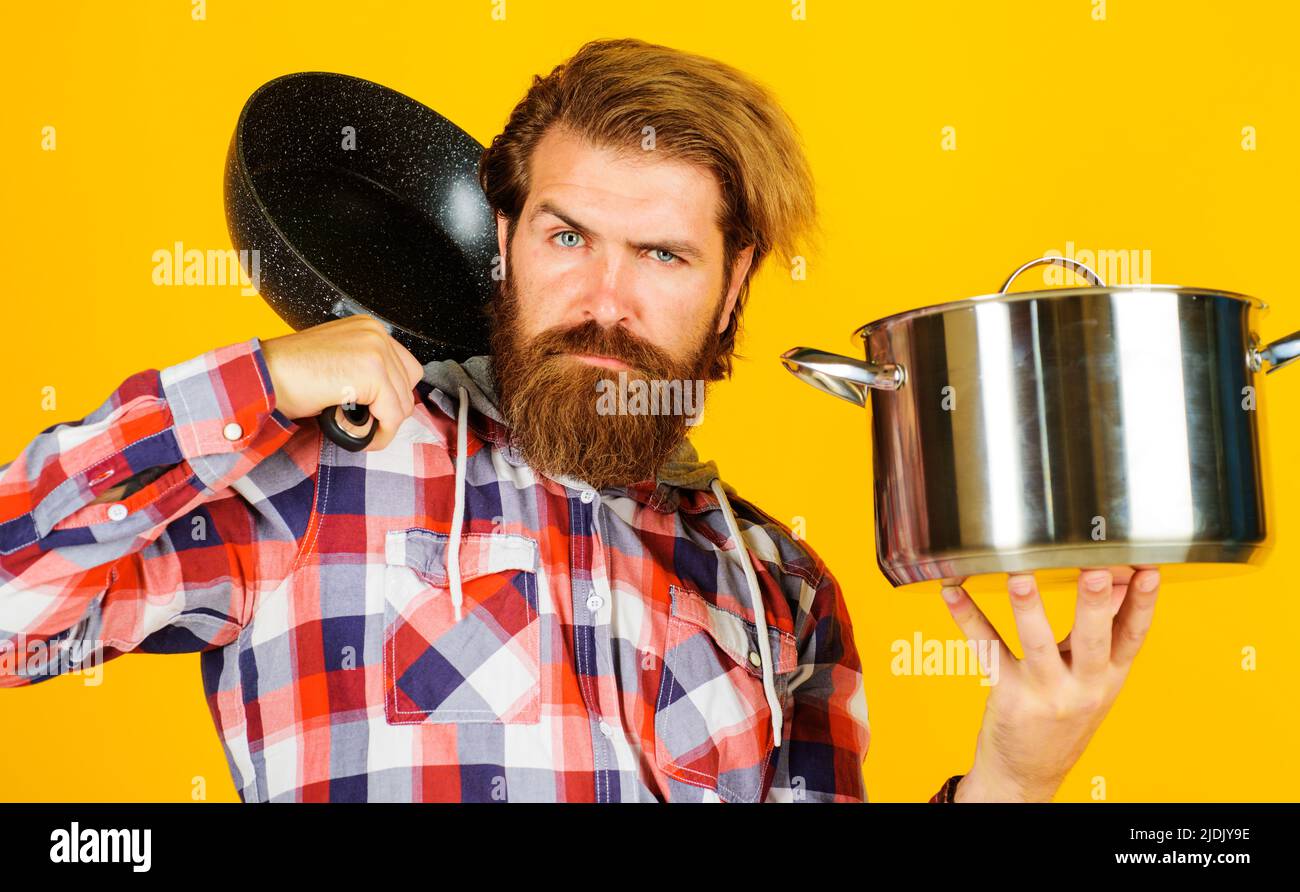 Man with saucepan or pot and frying pan. Shopping kitchenware. Cooking ...