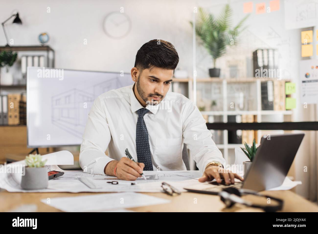 Bearded engineer indian man in yellow helmet and reflective vest ...