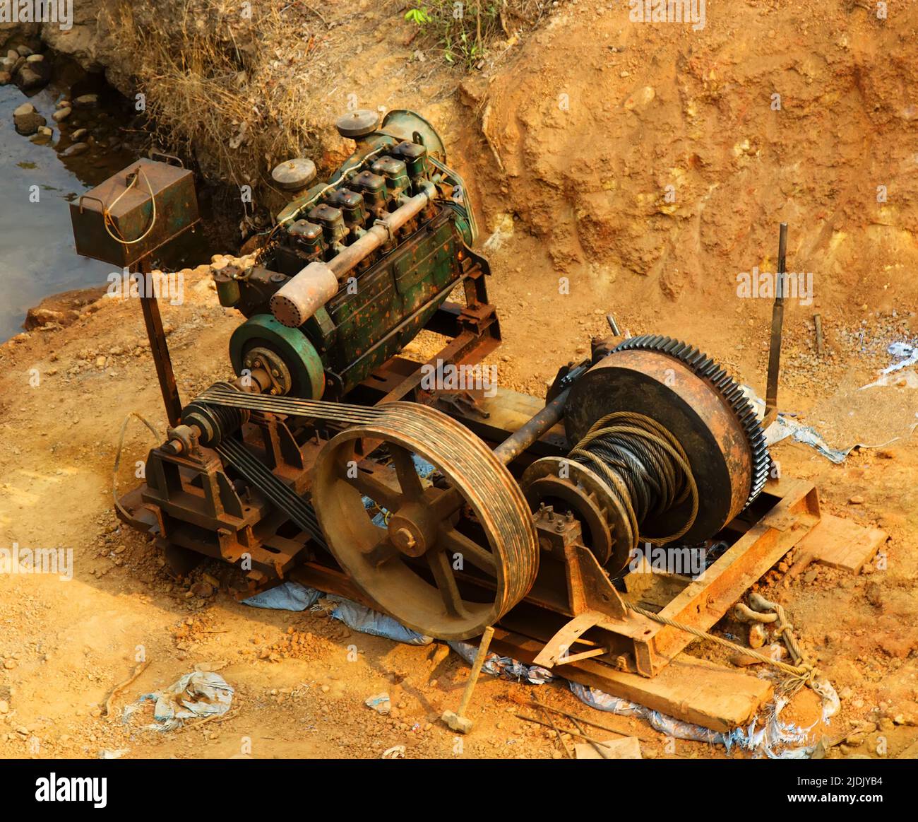 A very old heavy motor is adapted for pumping water and as a winch ...