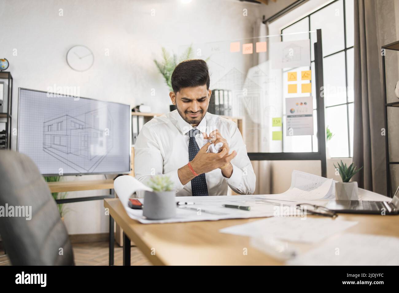 Arab enraged architect man or male builder crumpled a piece of paper ...