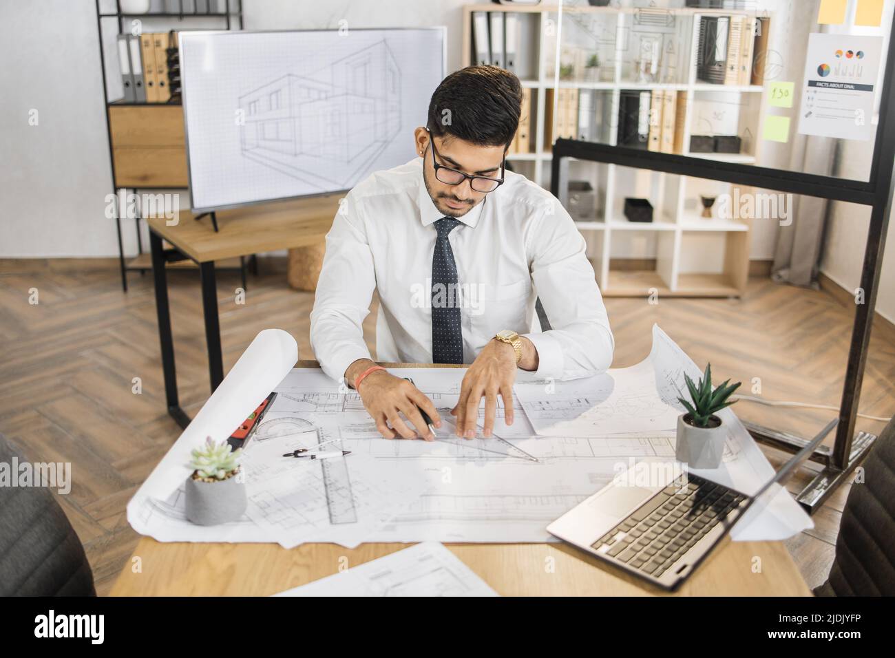 Qualified arab architect in white shirt, tie and glasses checking ...