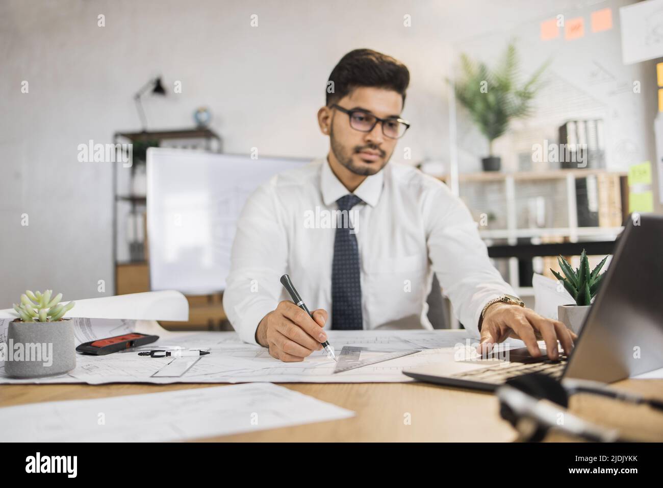 Architect hindu man builder hold pen, writing and drawing architectural ...