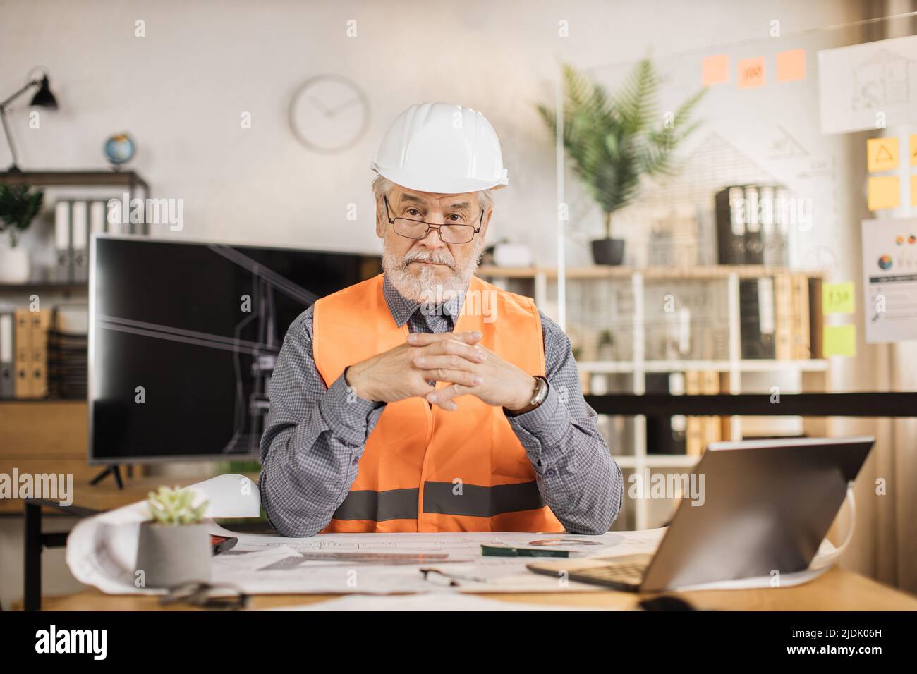 Close up portrait of mature builder drawing renovation house equipment ...