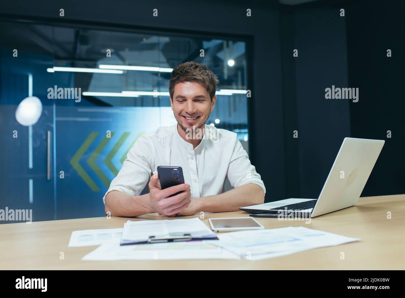 Young man, businessman, manager sitting in the office at his desk ...