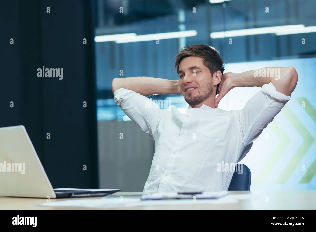 Young handsome man freelancer, businessman, manager in the office at ...