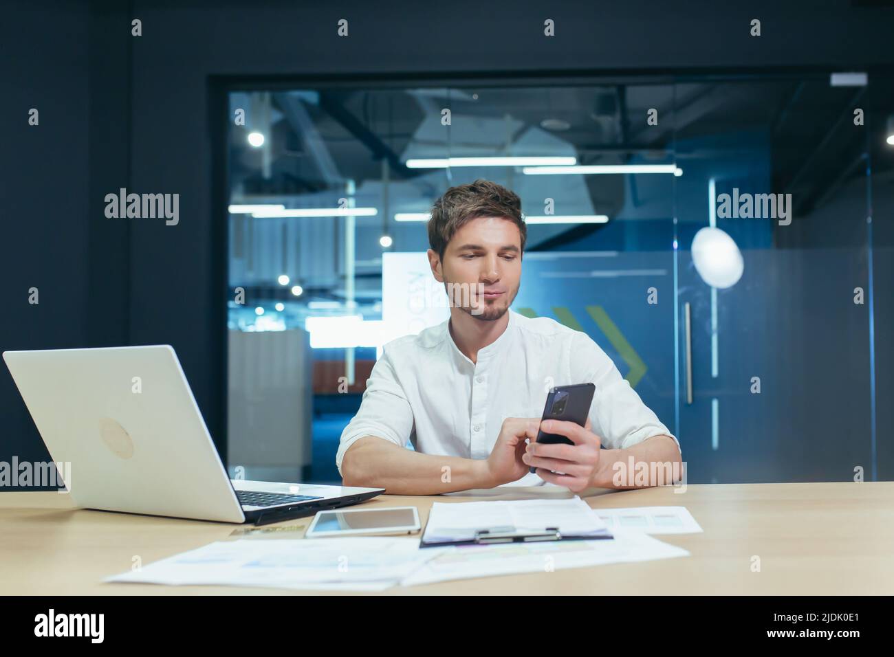 Young man, businessman, manager sitting in the office at his desk ...