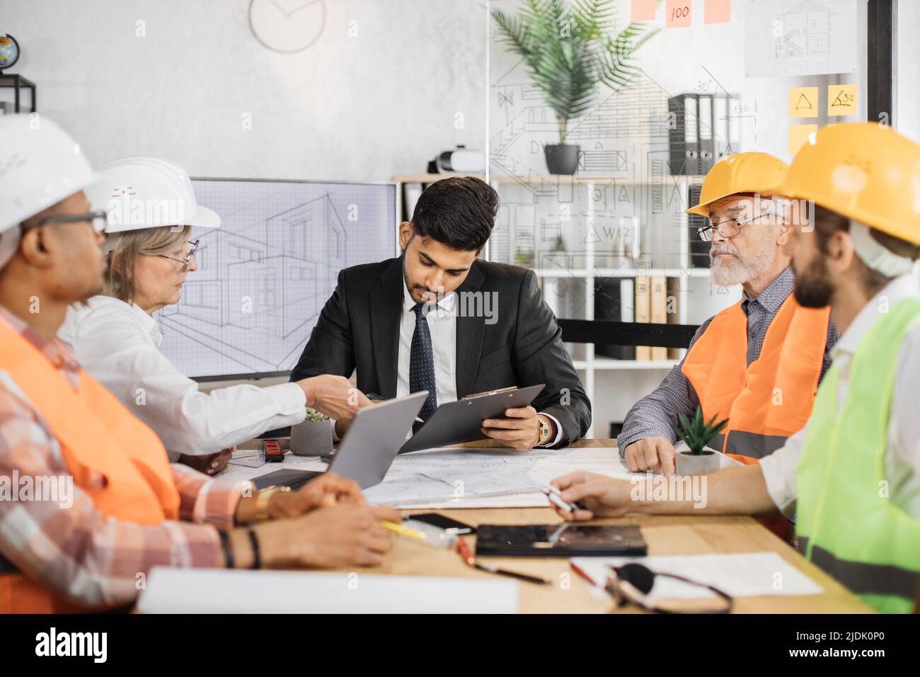 Indian businessman signs contract and documents of senior woman boss of ...