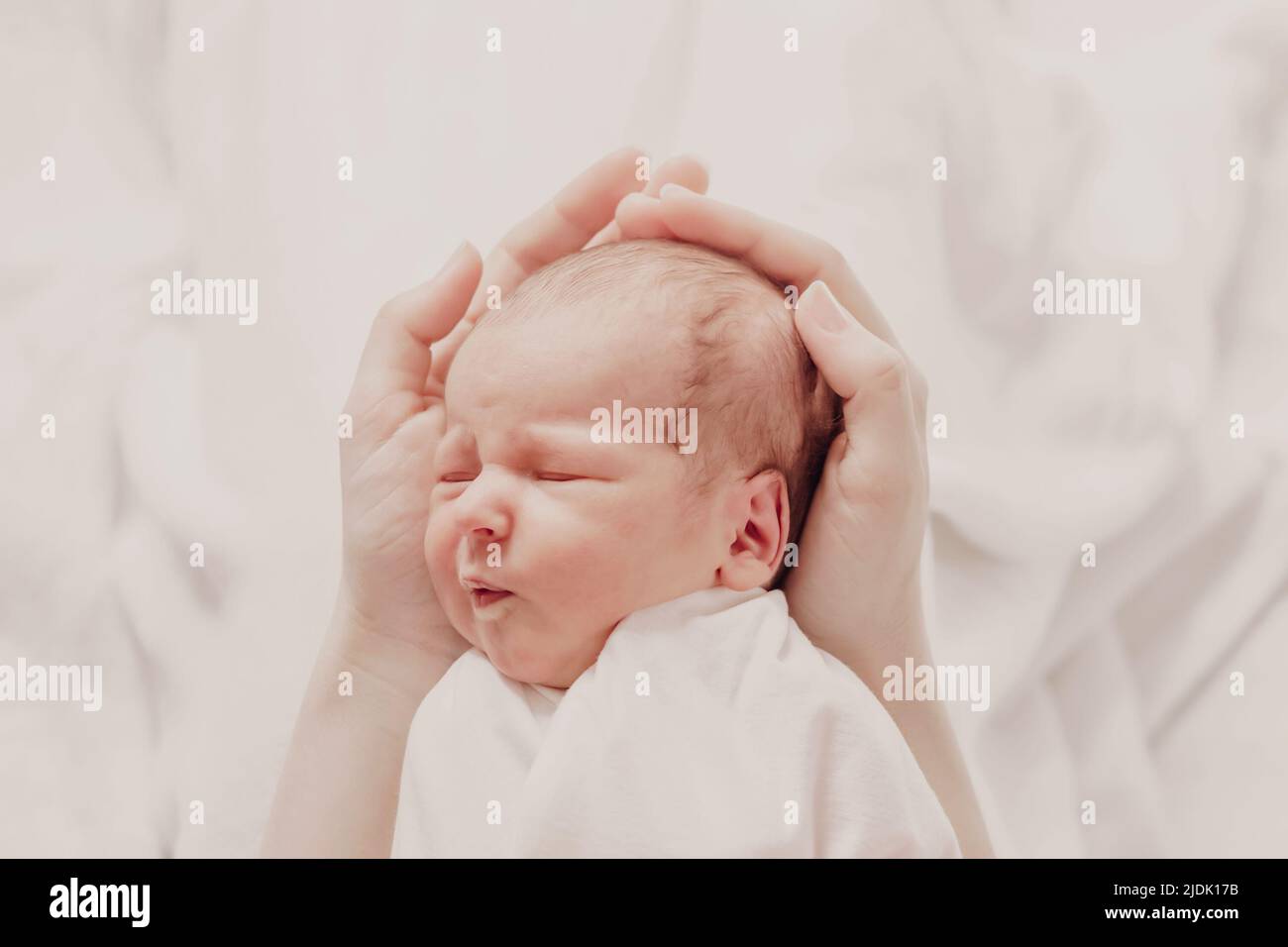 Mom gently holds a newborn baby in her palms. The first days of life ...