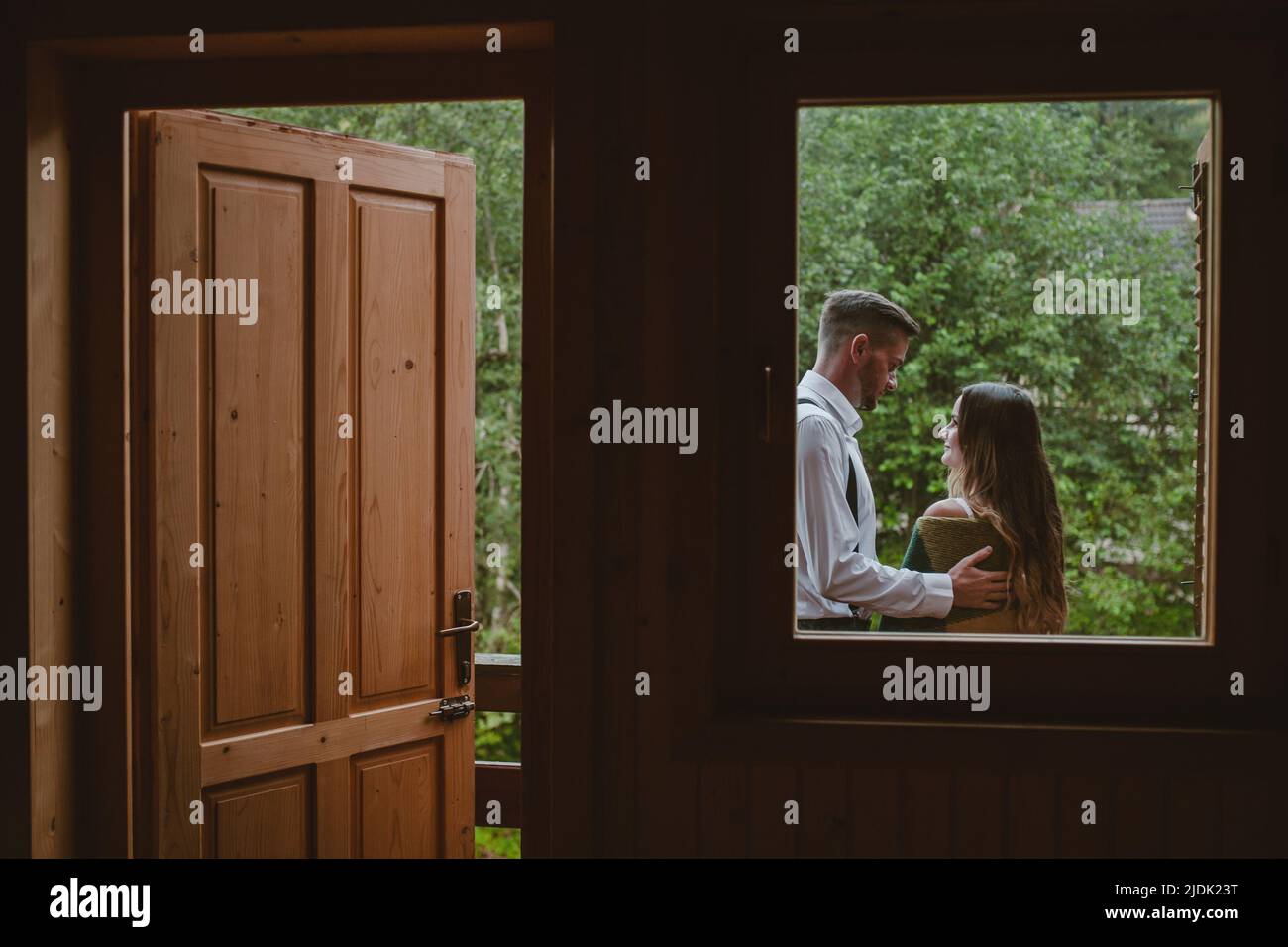 View from the window of the bride and groom sitting on the balcony ...