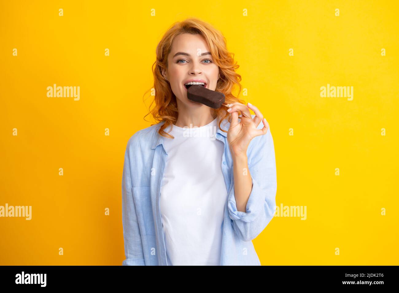 Portrait Of Beautiful Woman Eating Ice Cream On Orange Yellow