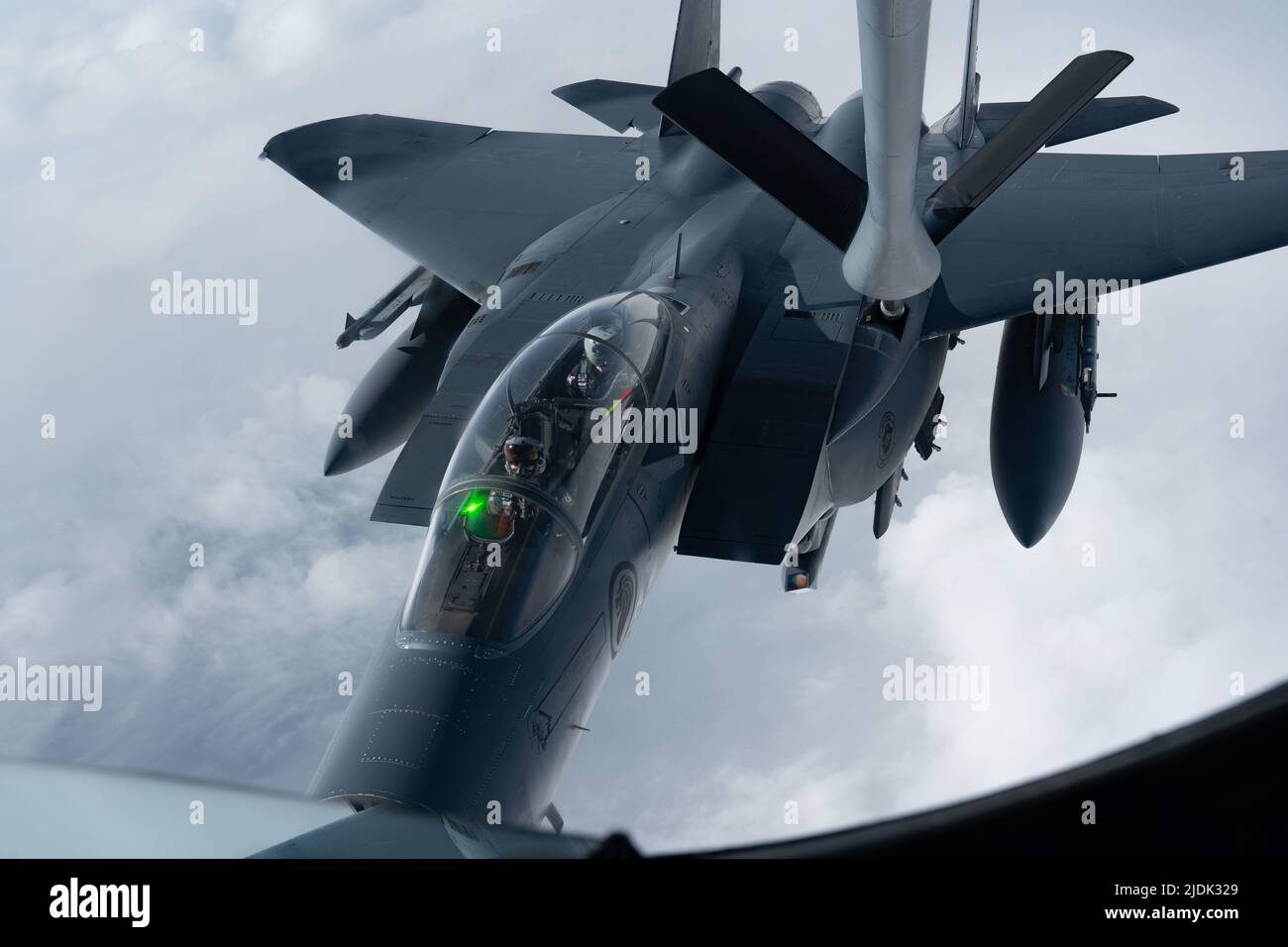 A F-15SG Strike Eagle receives fuel from a KC-135 Stratotanker over the ...