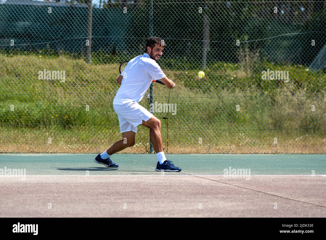 Tennis player performing a drop shot on court Stock Photo - Alamy