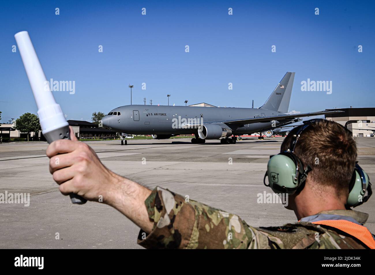 An Airman assigned to the 305th Air Mobility Wing marshals in a KC-46A ...