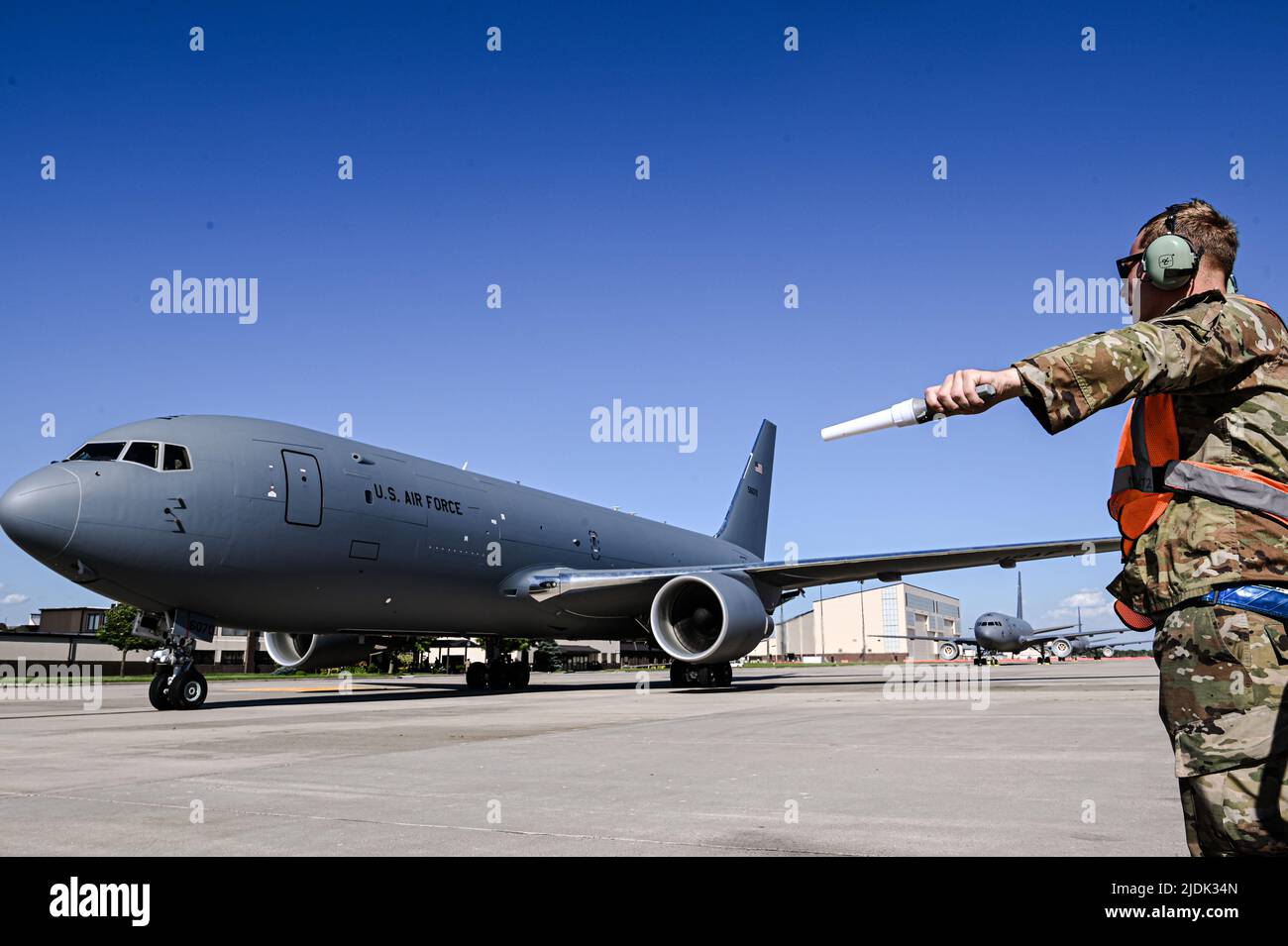 An Airman assigned to the 305th Air Mobility Wing marshals in a KC-46A ...