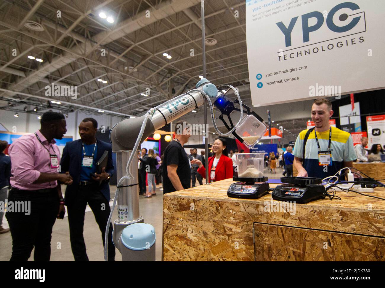 Toronto, Canada. 21st June, 2022. People look at a kitchen robot at a ...
