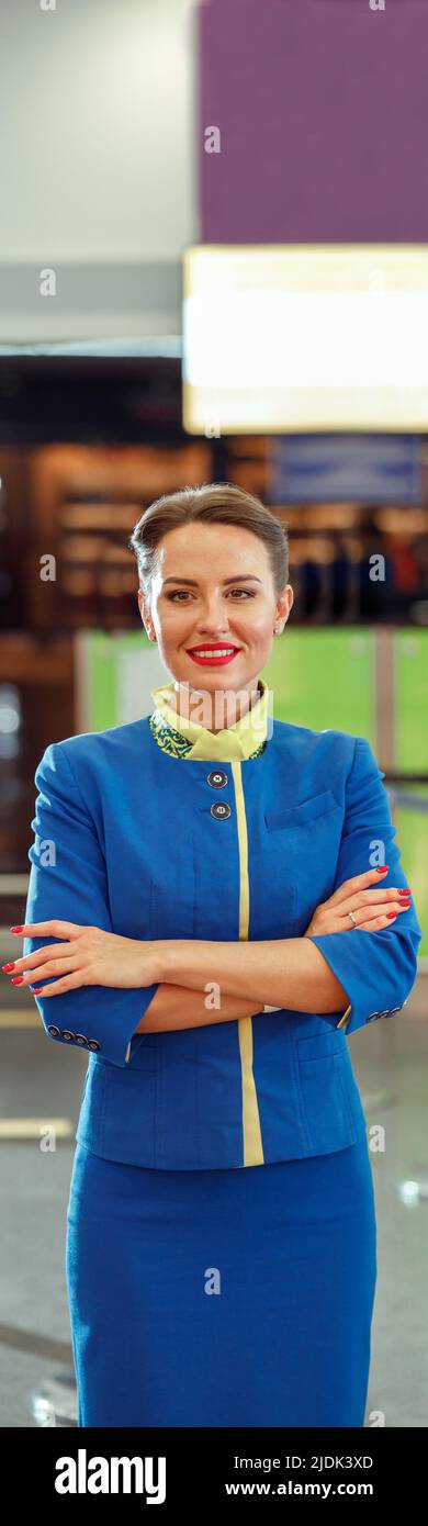 Joyful woman air hostess standing in airport terminal Stock Photo - Alamy