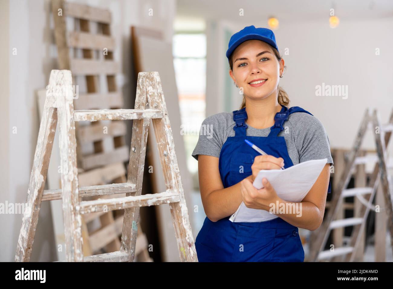 Woman foreman checks the completed construction work on drawing Stock ...