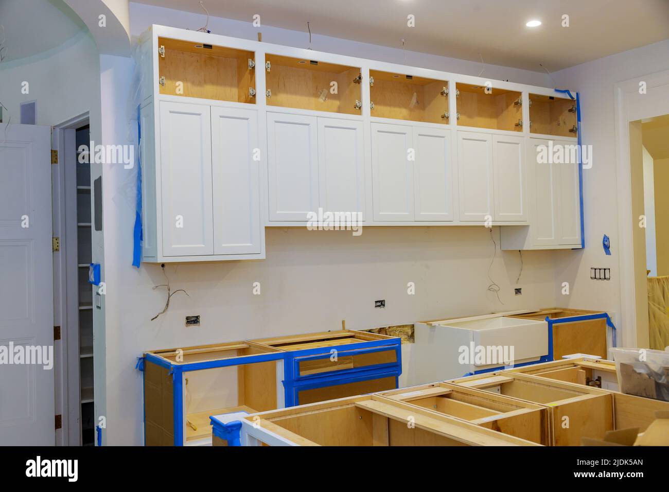 Installing and assembling modern kitchen cabinets Stock Photo - Alamy