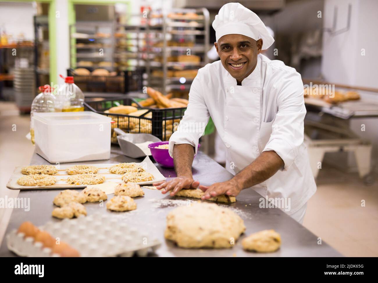 Making sweet buns and eggs in bakery kitchen Stock Photo - Alamy