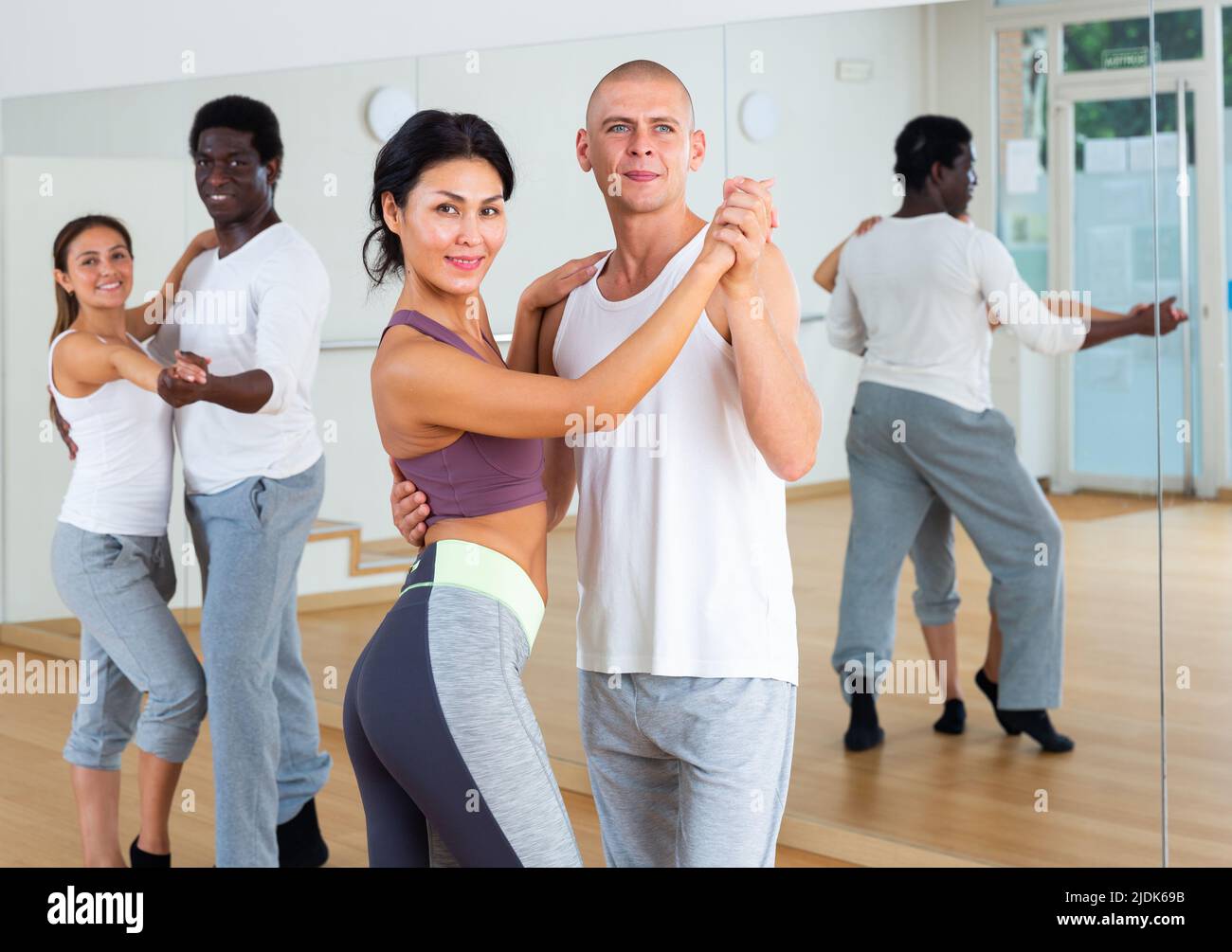 Young couples practicing active dance in pair Stock Photo - Alamy