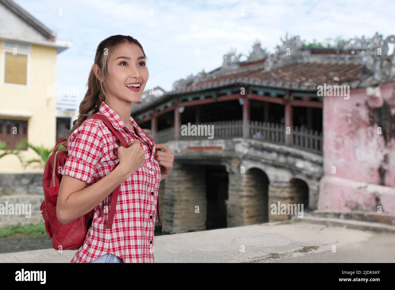 Female backpackers in red plaid shirts show excitement at Asia's old ...