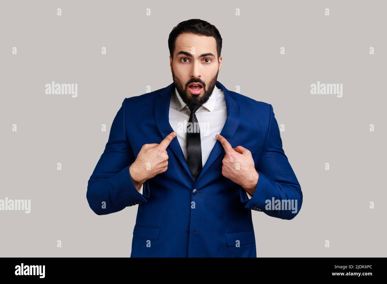 Astonished bearded man pointing himself, looking with surprised ...