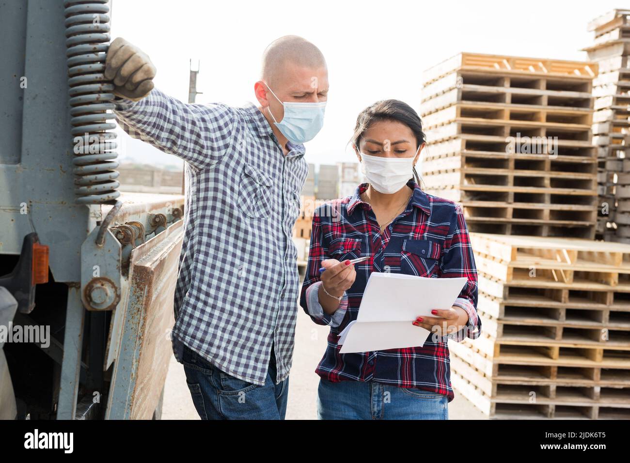 Woman manager protective mask giving instructions to a worker at the ...