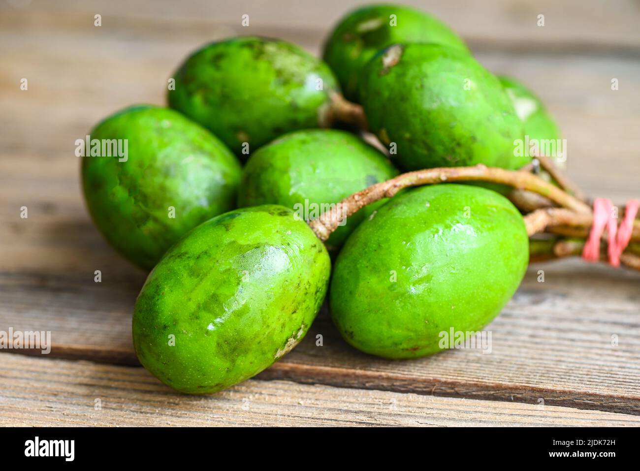 Fruit of Elaeocarpus hygrophilus on wooden background , Spondias mombin ...